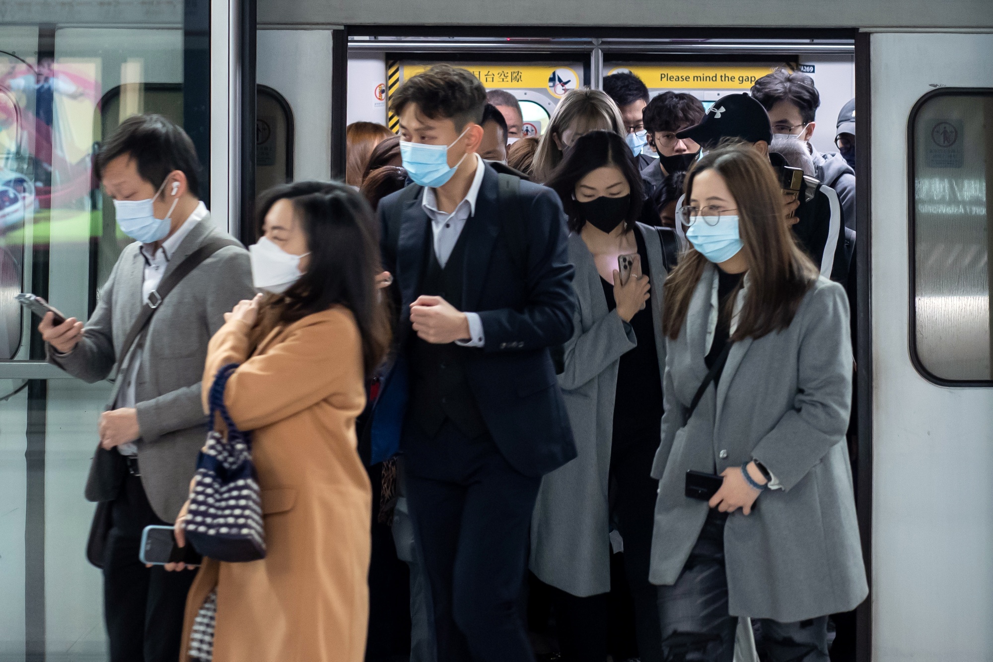 Hong Kongers Keep Wearing Masks Despite End of 945-Day Mandate - Bloomberg