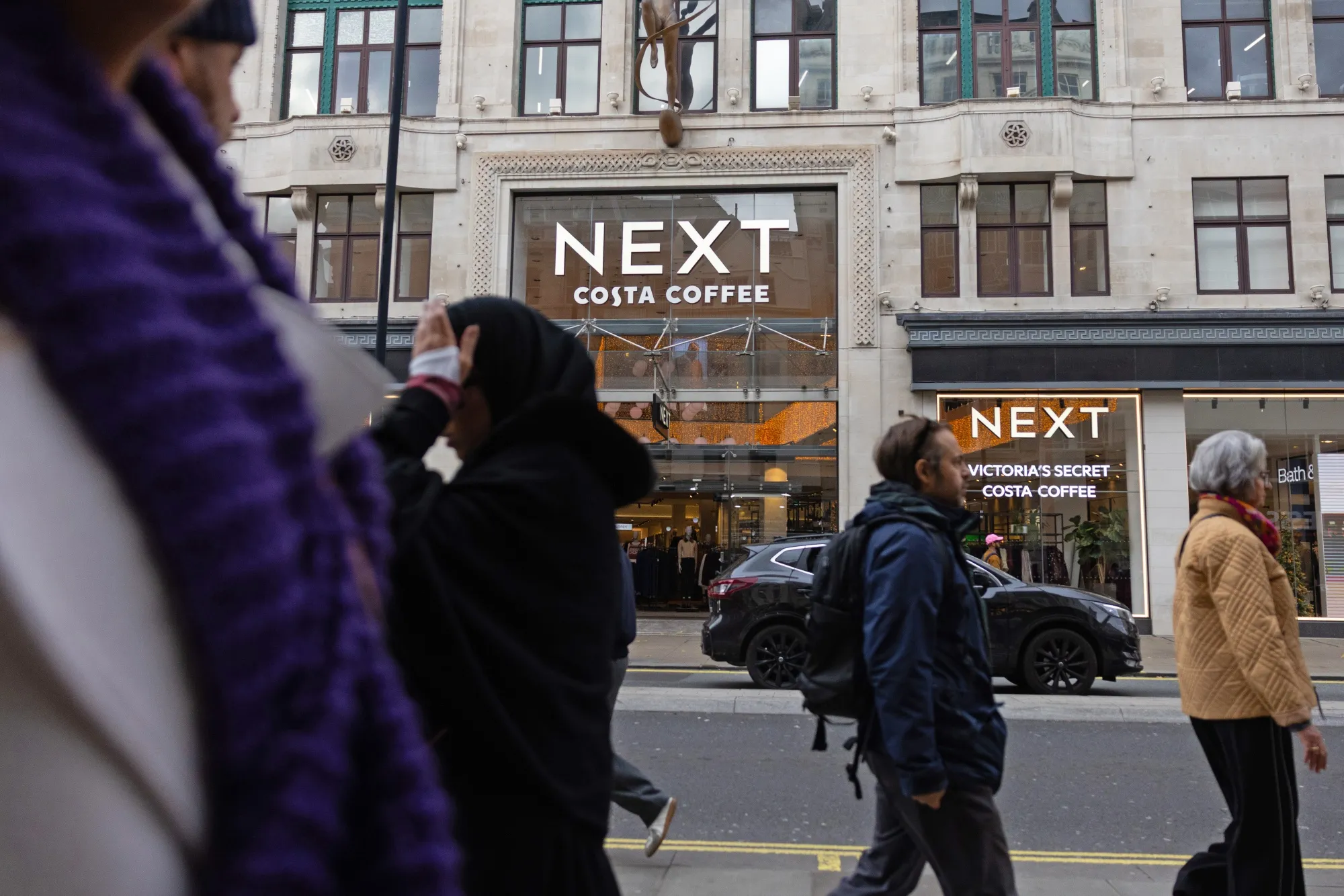 Next Lifts Guidance Again as Shoppers Defy UK Economic Woes - Bloomberg